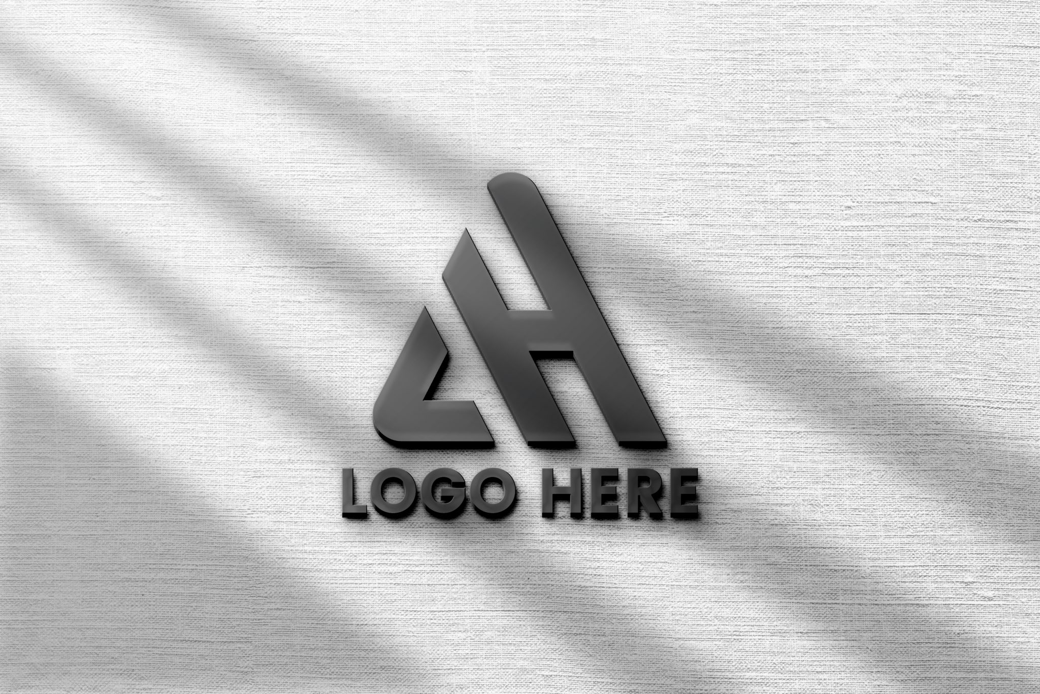 Black 3D Logo Mockup on Gray Wall – GraphicsFamily