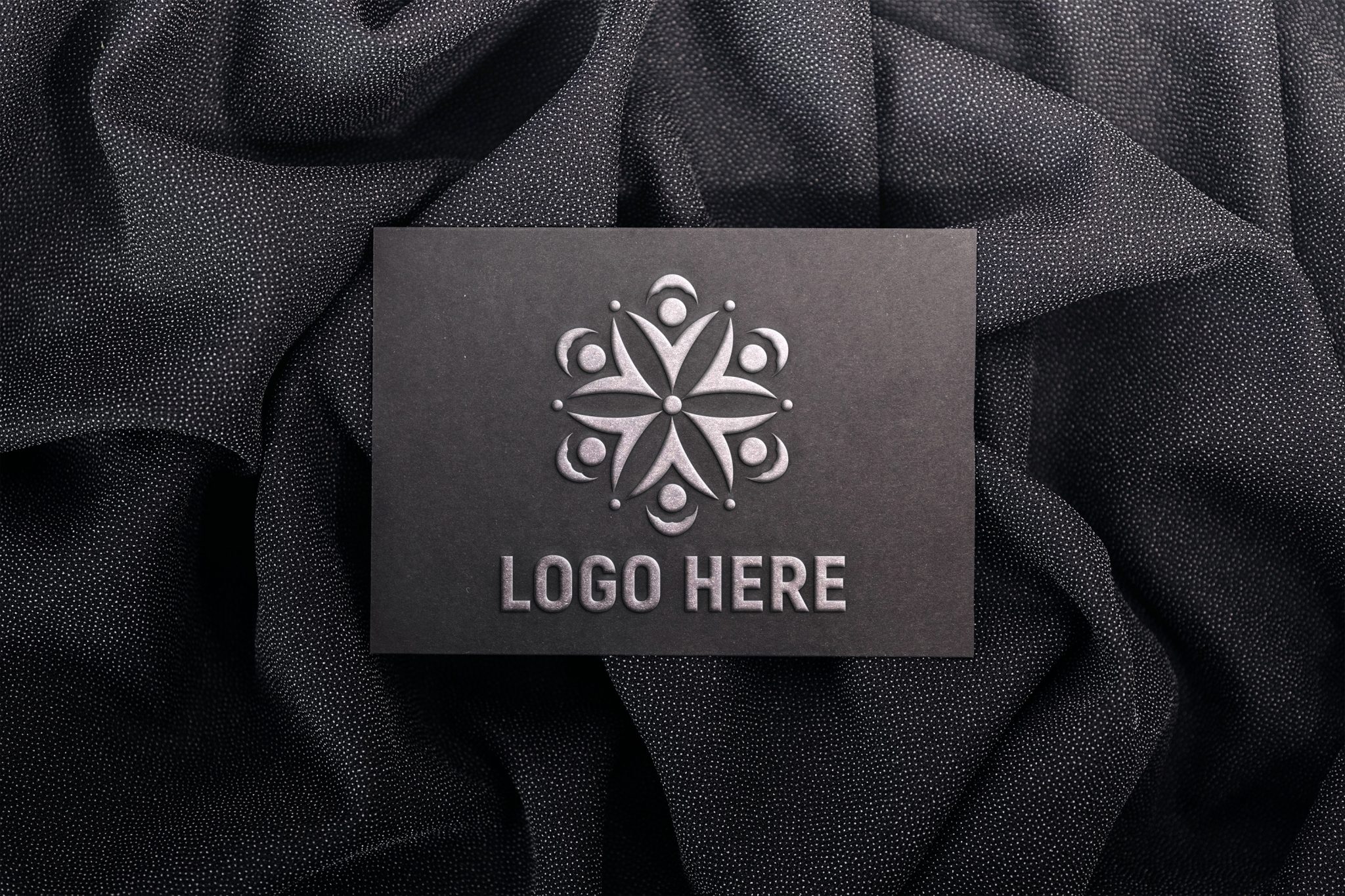 Embossed logo mockup on black paper – GraphicsFamily