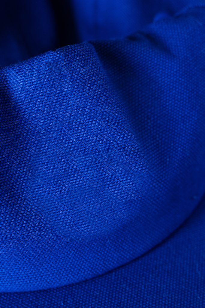 Free Blue and White Textile Logo Mockup – GraphicsFamily